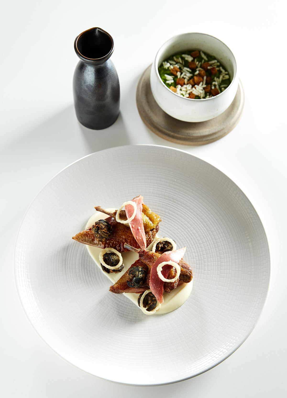 Squab pigeon, snails, cauliflower and parsley risotto